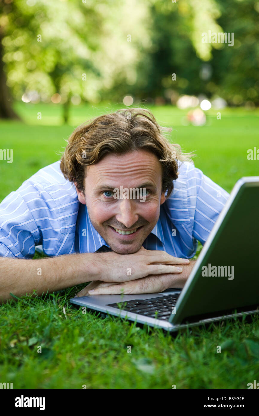 A man with a laptop in a park Sweden Stock Photo - Alamy