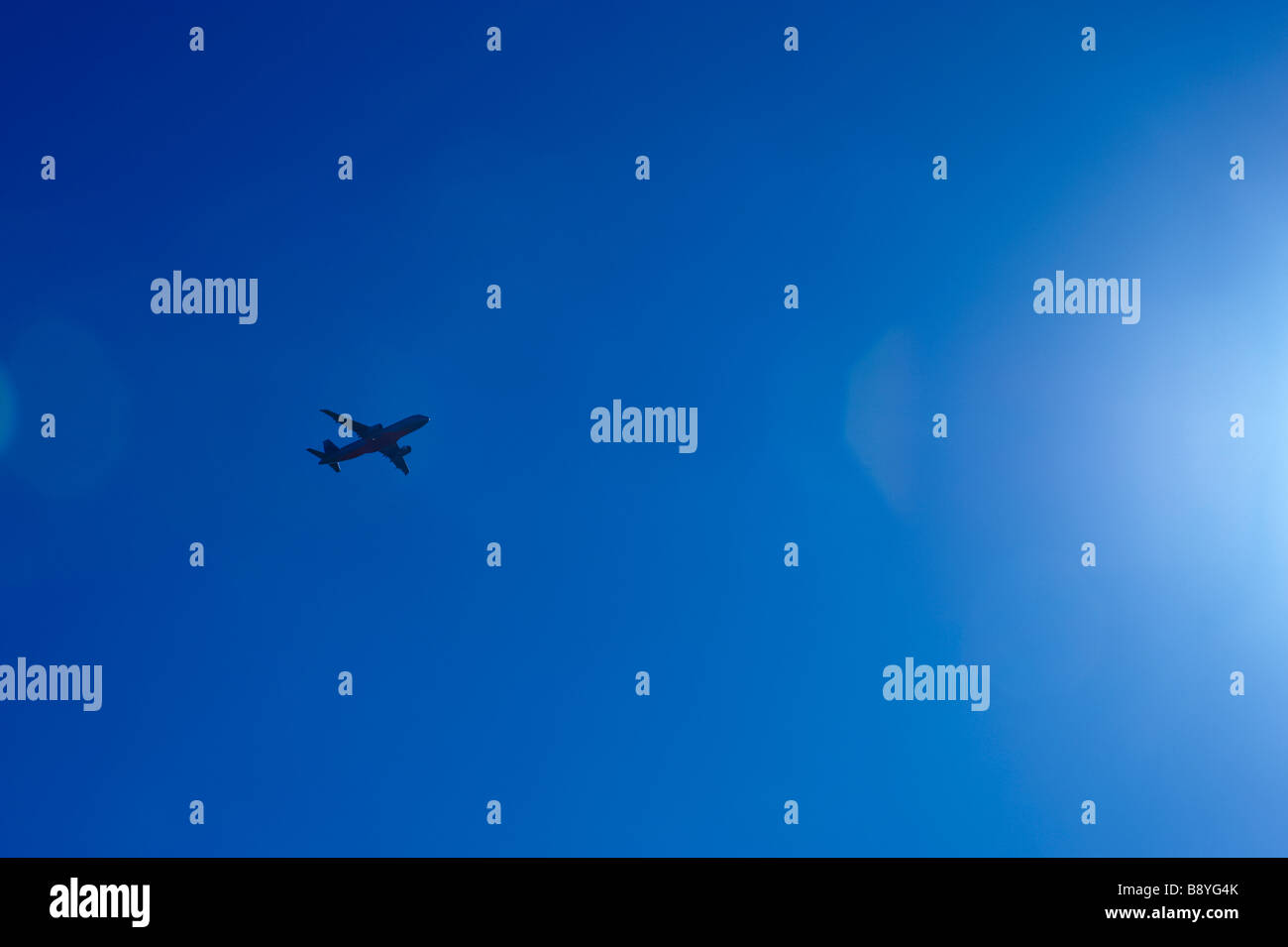Airliner flying into the sun Stock Photo - Alamy