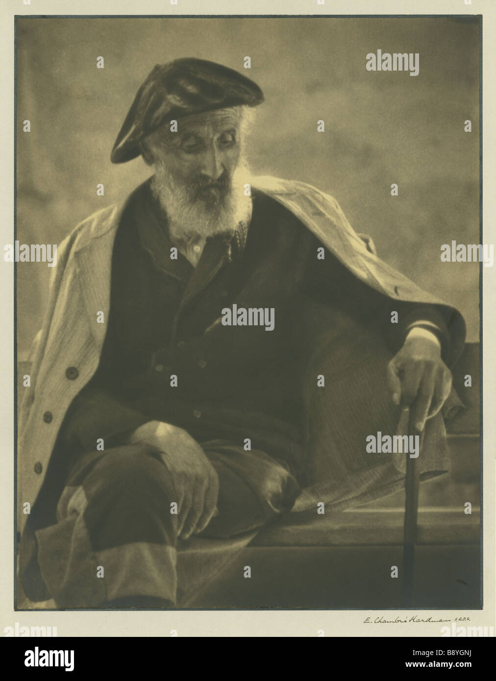 Photograph by E Chambre Hardman of an old Frenchman seated on a bench ...