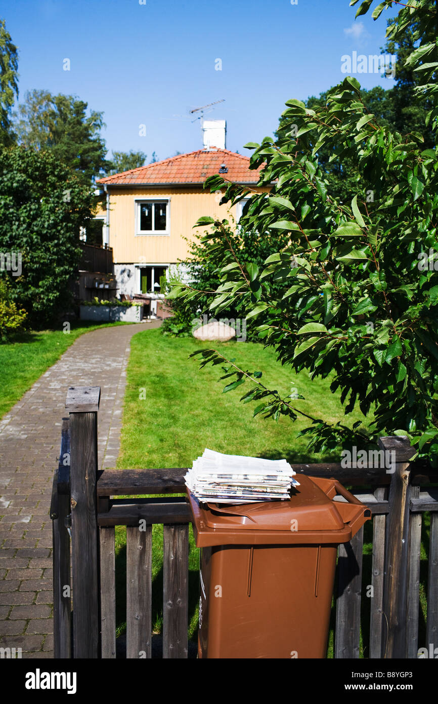 A garbage bin outside a garden Stock Photo - Alamy