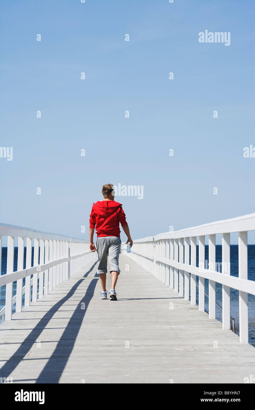 Rear man walking on jetty hi-res stock photography and images - Alamy