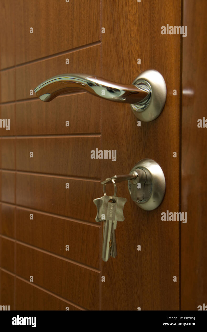 wooden door with the key in the lock Stock Photo - Alamy