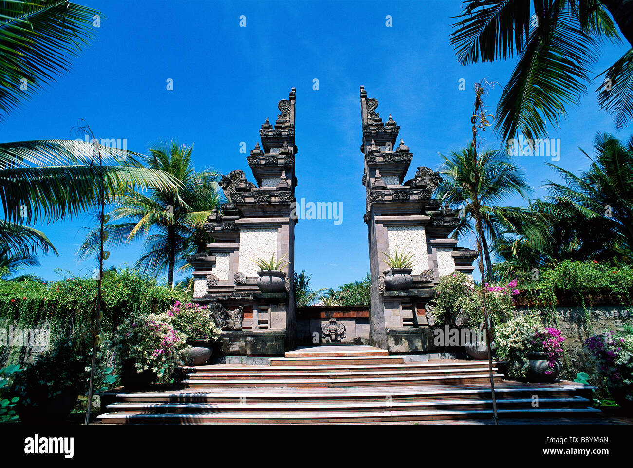 Palm trees and pillars Bali Stock Photo - Alamy