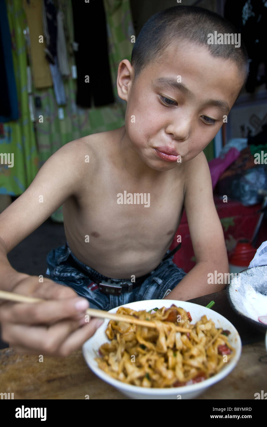 Chinese kid eating noodles, Pingyao, Shaanxi province, China Stock ...