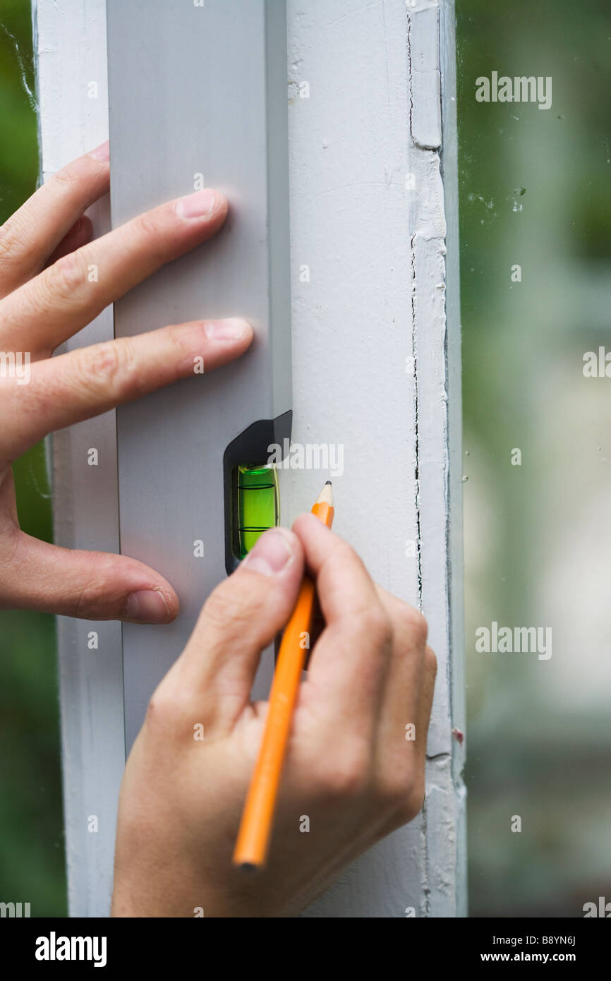 A man using a spirit level Sweden Stock Photo - Alamy