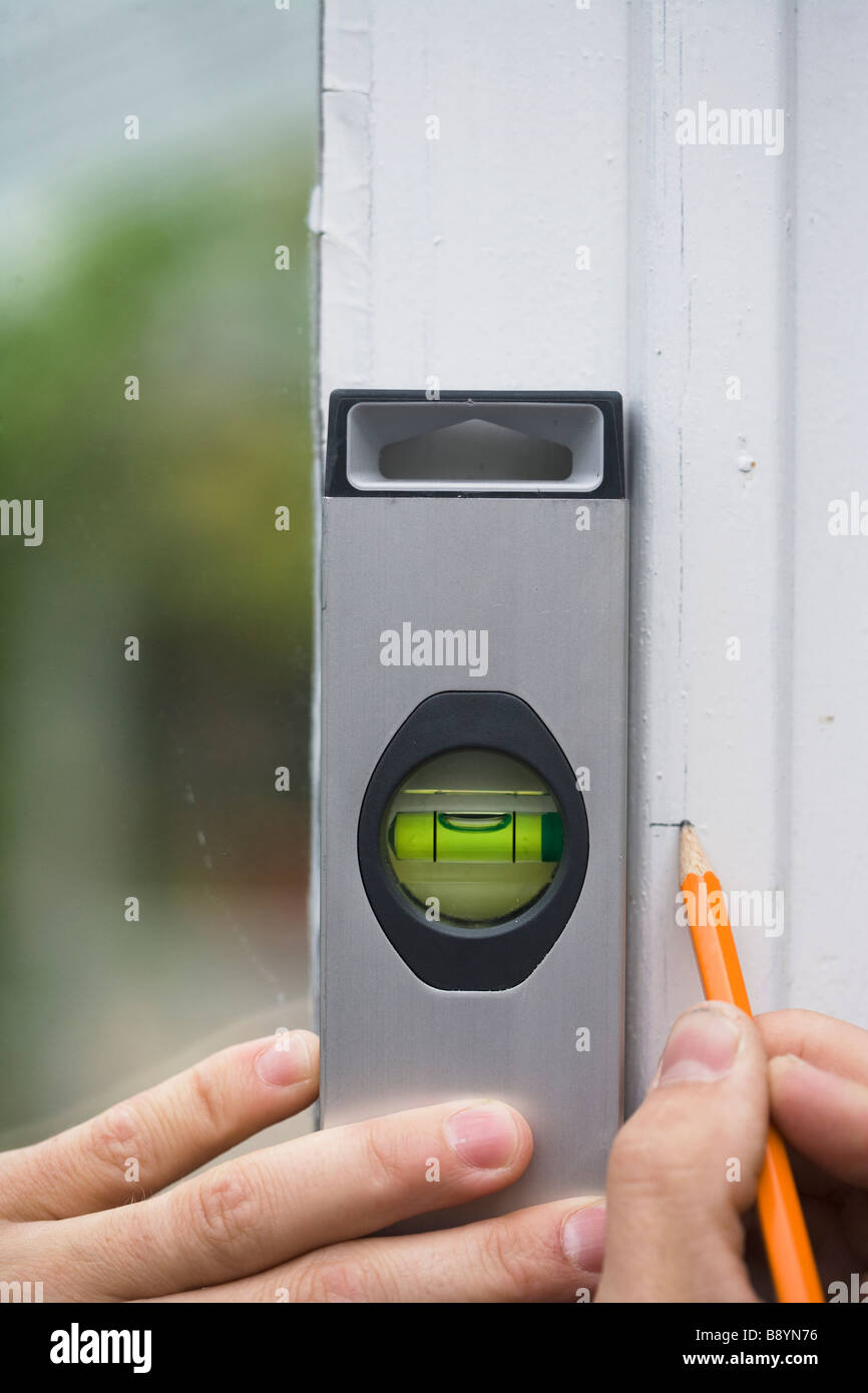 A man using a spirit level Sweden Stock Photo - Alamy