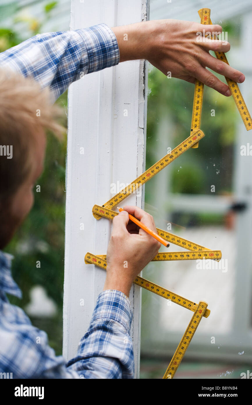 A man using a folding rule Sweden Stock Photo - Alamy