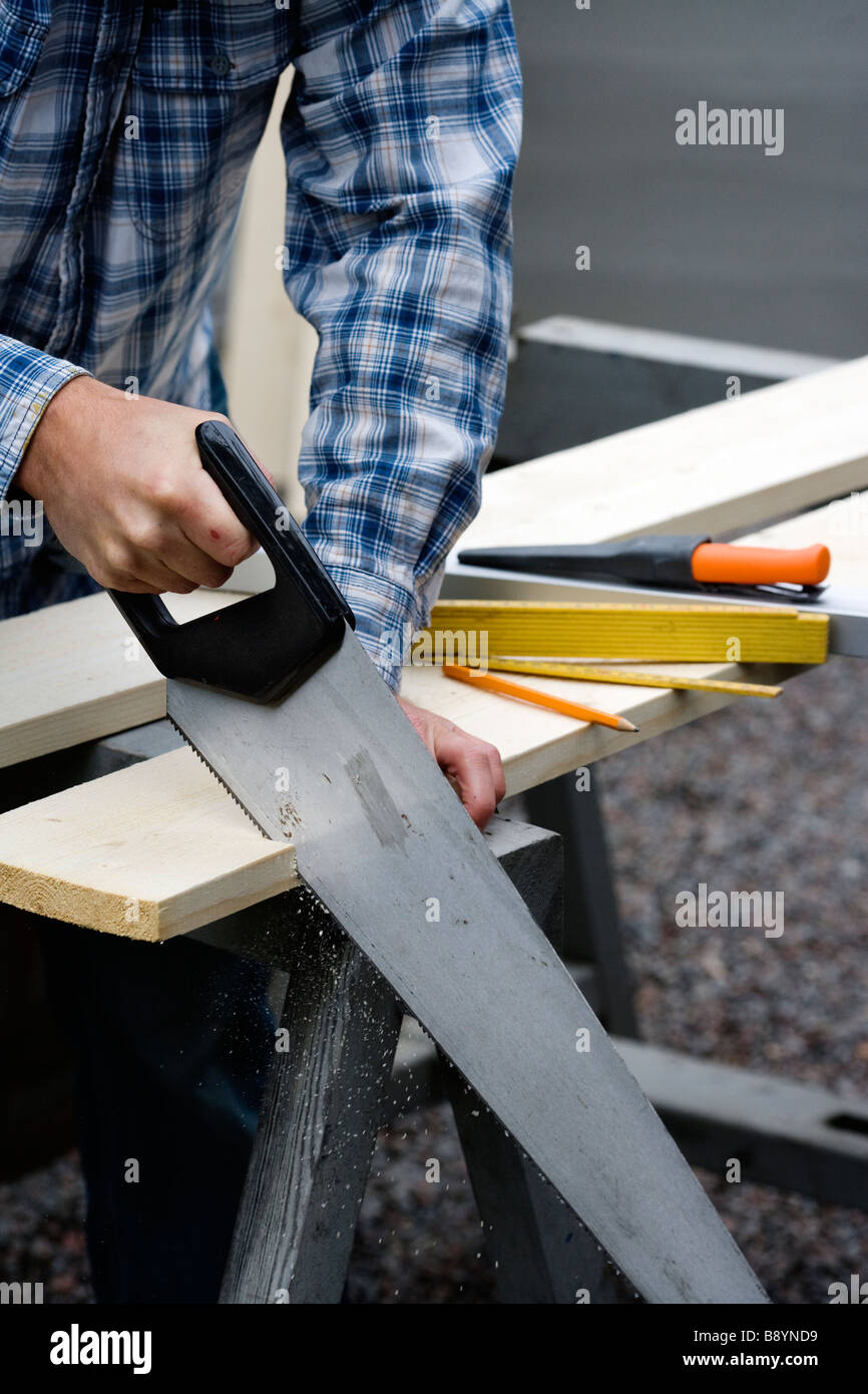 A man using a saw Sweden Stock Photo - Alamy