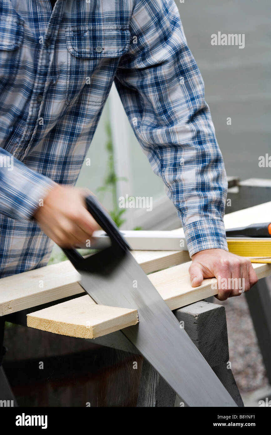 A man using a saw Sweden Stock Photo - Alamy