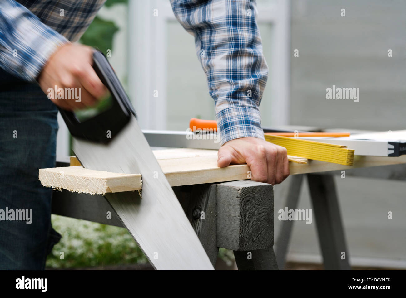 A man using a saw Sweden Stock Photo - Alamy