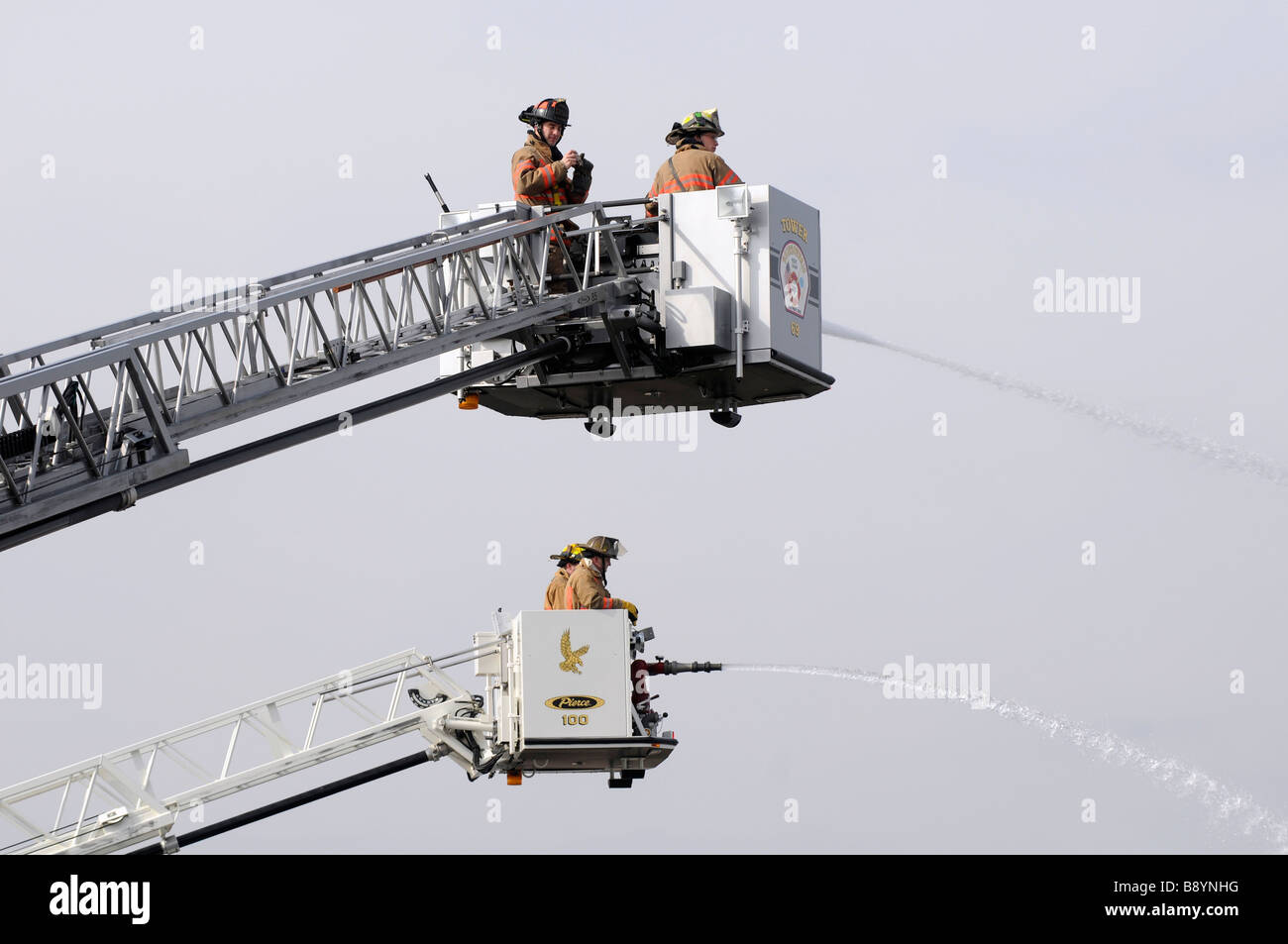 American firefighters in aerial towers Stock Photo - Alamy