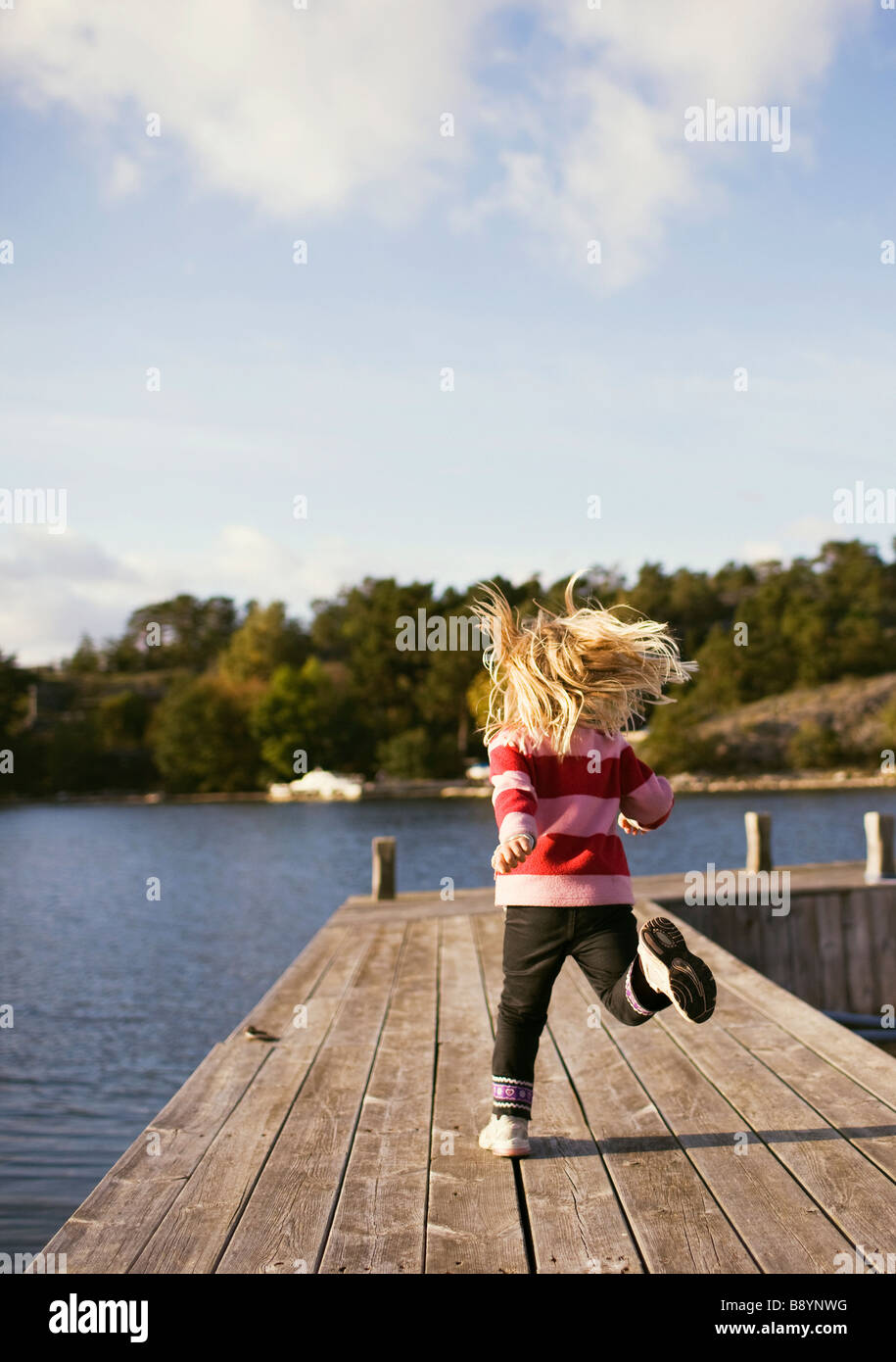 A girl running on a jetty Stockholm archipelago Sweden Stock Photo - Alamy