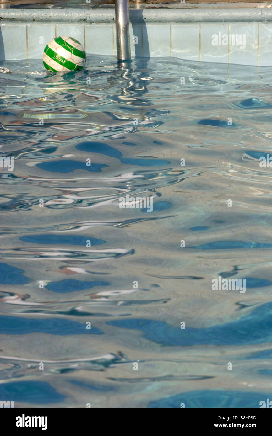 Green and white ball floating in a swimming pool Stock Photo - Alamy
