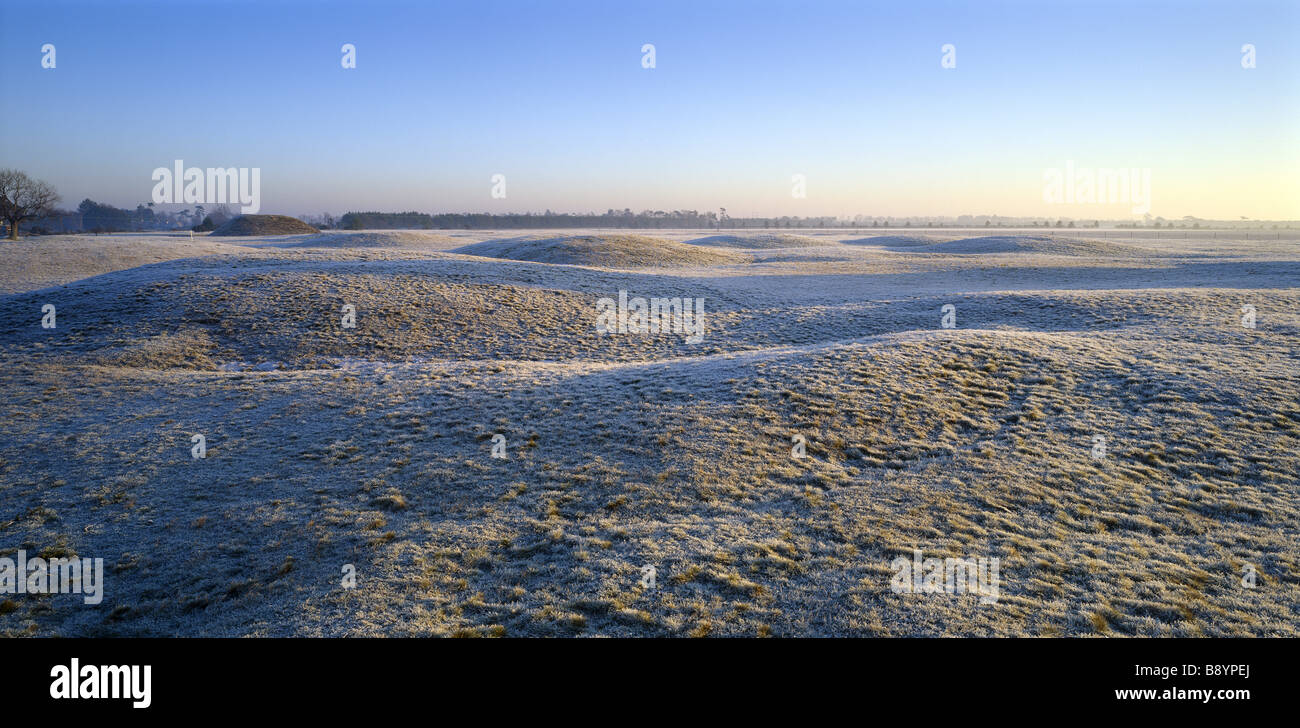 A view across the frost covered burial mounds at Sutton Hoo on a frosty ...