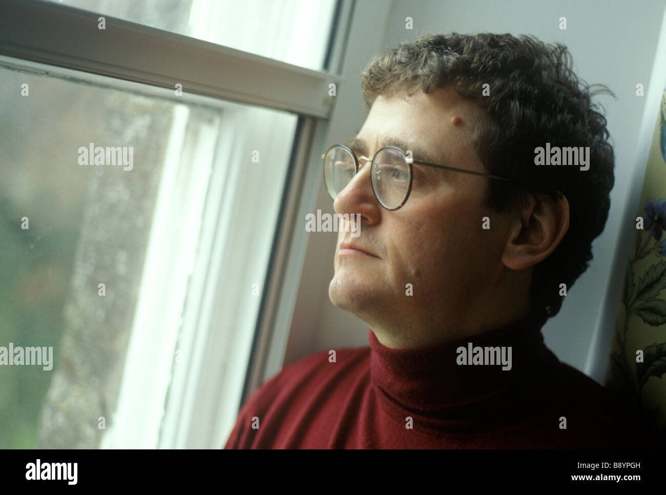 depressed man looking out of the window Stock Photo - Alamy