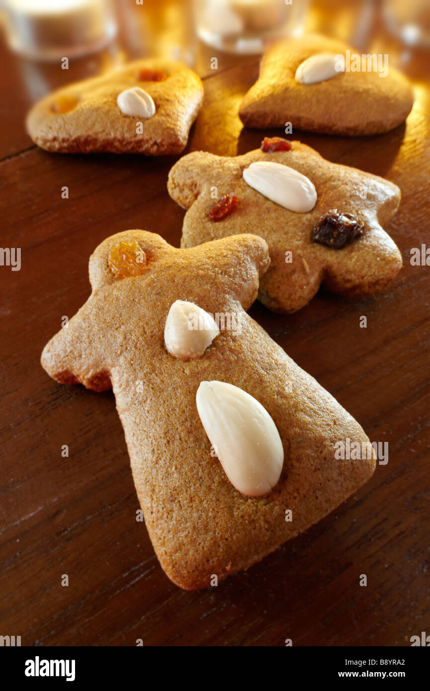 Fresh baked spicy christmas biscuits in s festive setting on a wooden ...