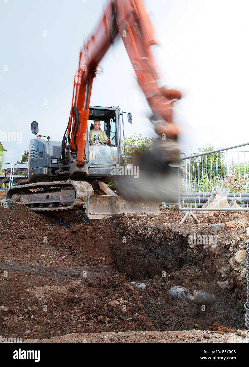Jcb digging a trench on a construction site Stock Photo - Alamy