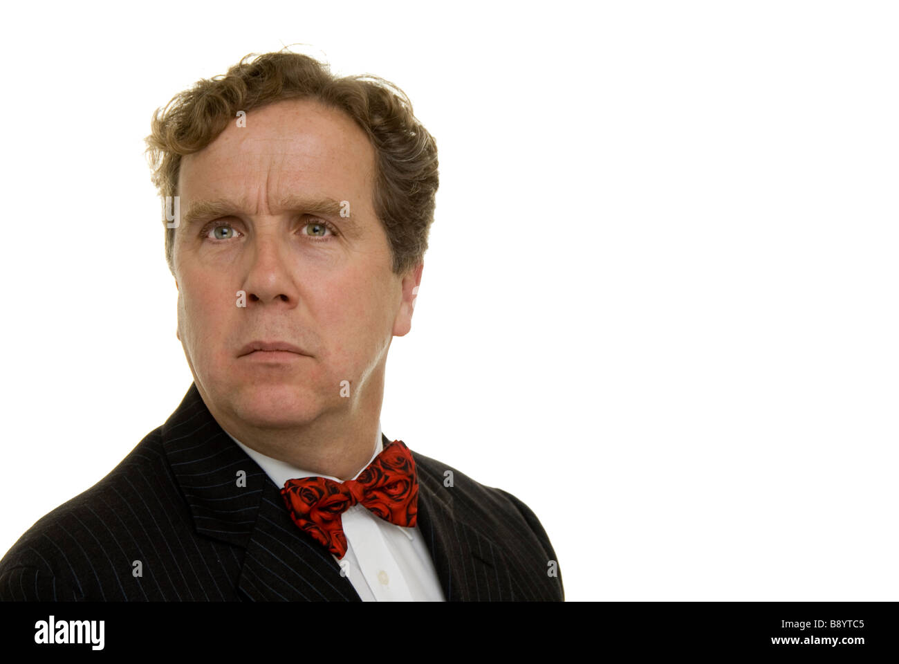 man wearing a bow tie looking cross Stock Photo - Alamy