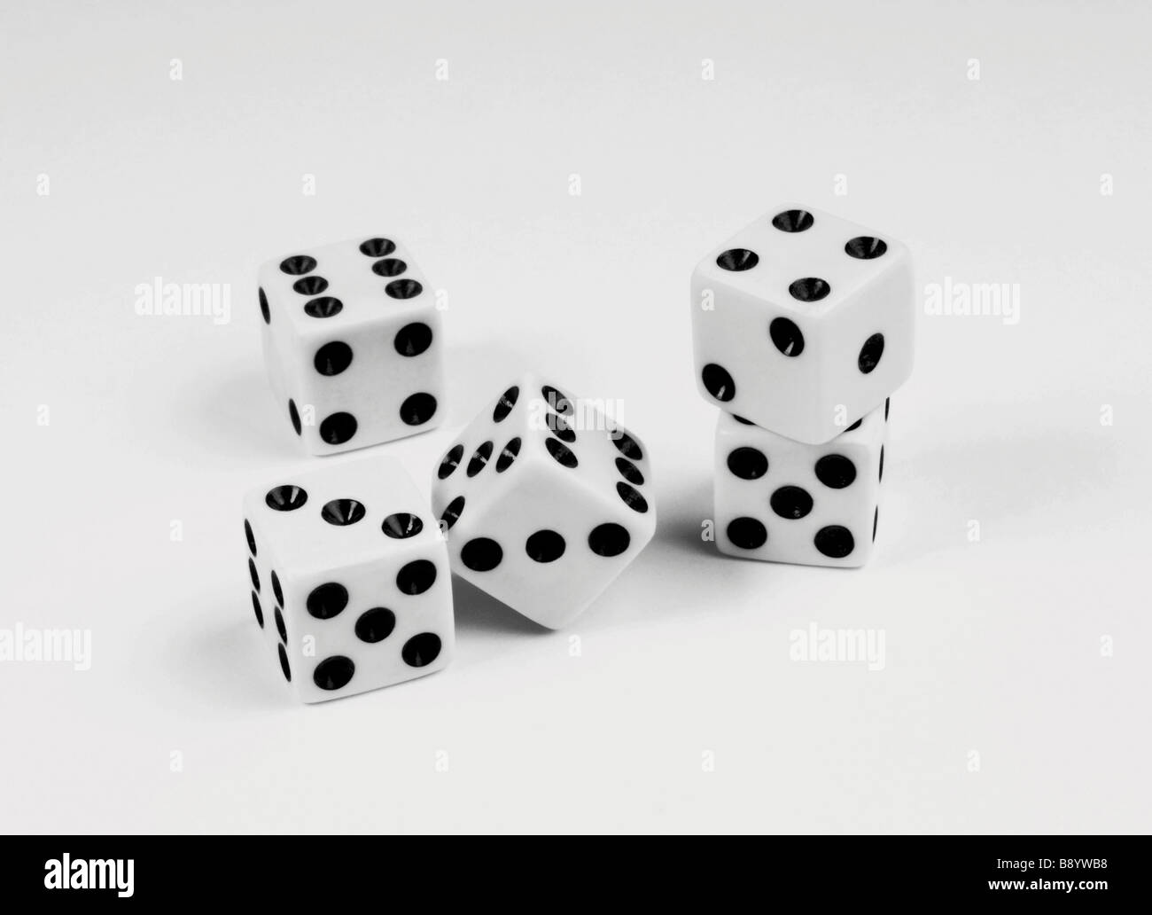 Five white dice game on white background Stock Photo - Alamy