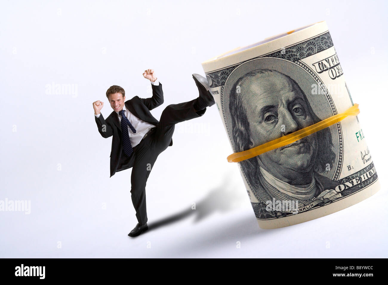 Man raising foot toward the curled US paper dollars Stock Photo - Alamy
