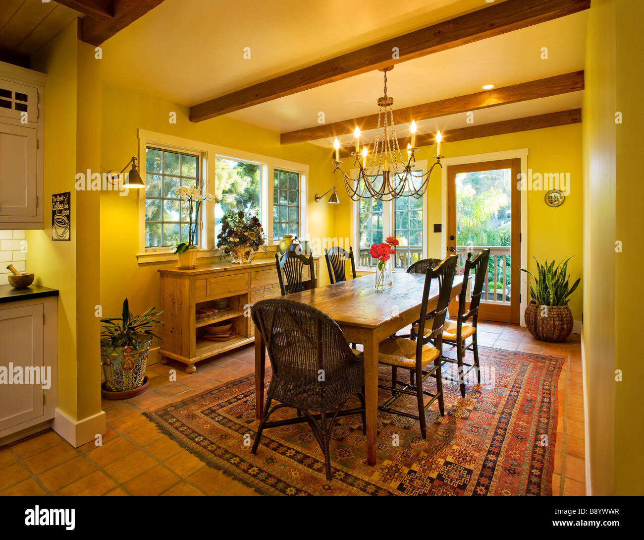 Yellow dining room with wooden ceiling beams Stock Photo - Alamy