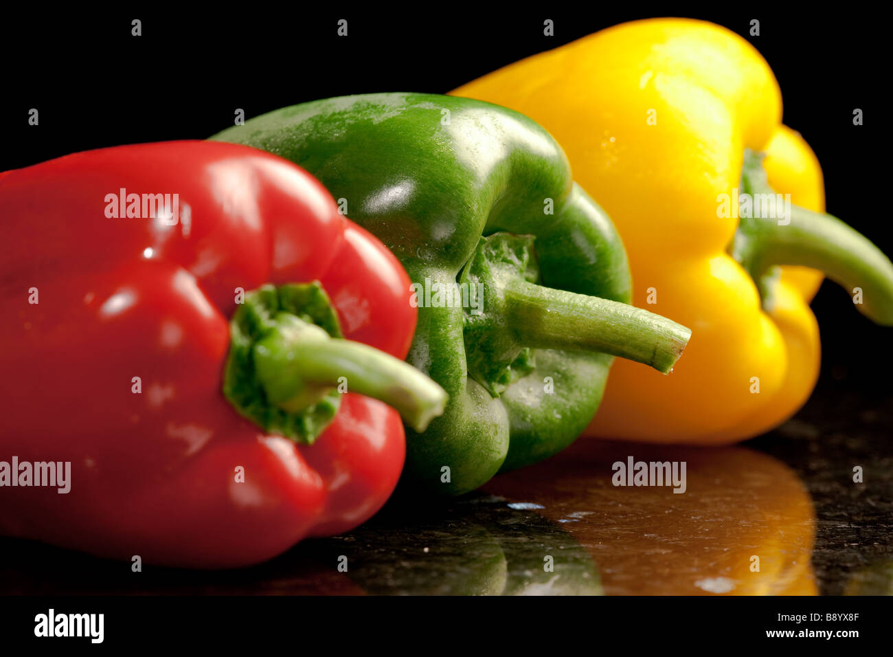 A red, green and yellow capsicum in a row Stock Photo - Alamy