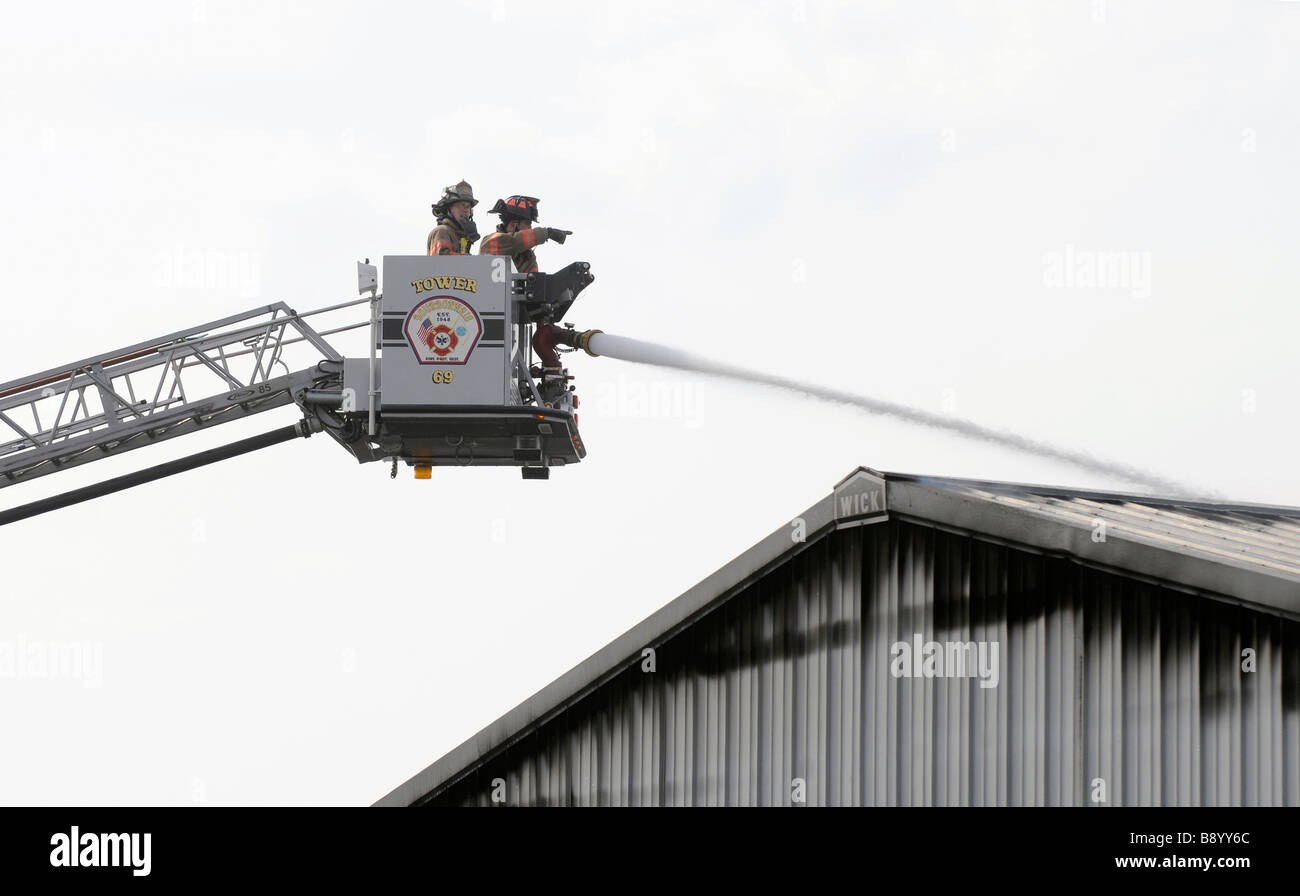 American firefighters in aerial an tower direct firefighting efforts ...