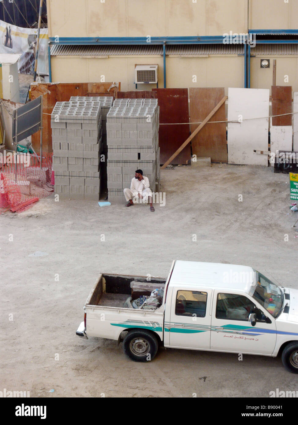 Worker waiting on a building site out of the sun Stock Photo - Alamy