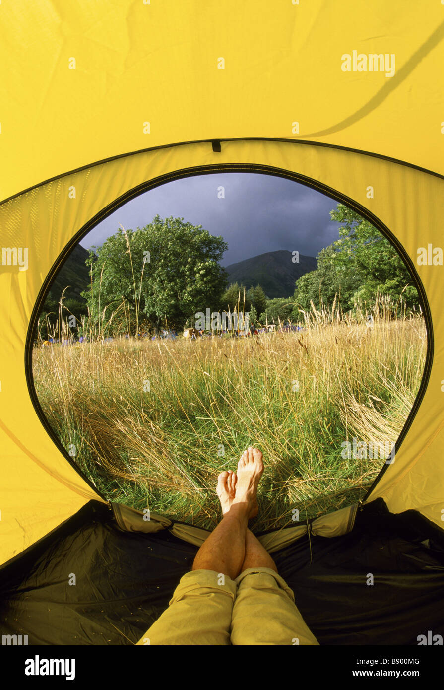 Close up view of male camper's crossed legs in a tent, on the NT ...