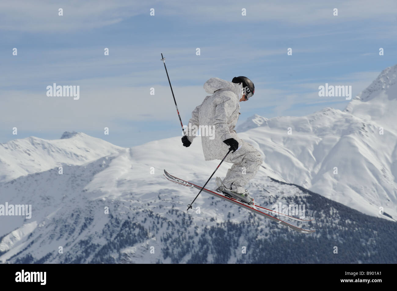 Freeskier jumping wildly into the skies in the swiss alps Stock Photo ...