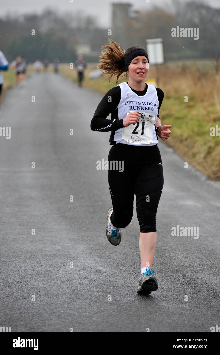 young women running in road race with long hair flying out behind ...