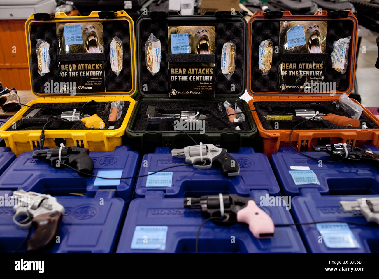 Guns are displayed on a vendors table for sale at a gun show in ...