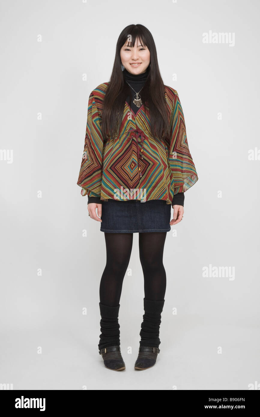 Portrait of a young woman standing Stock Photo - Alamy