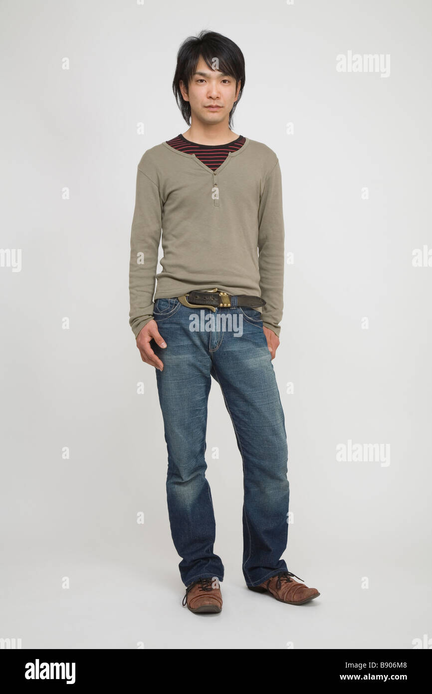 Portrait of a young man standing Stock Photo - Alamy