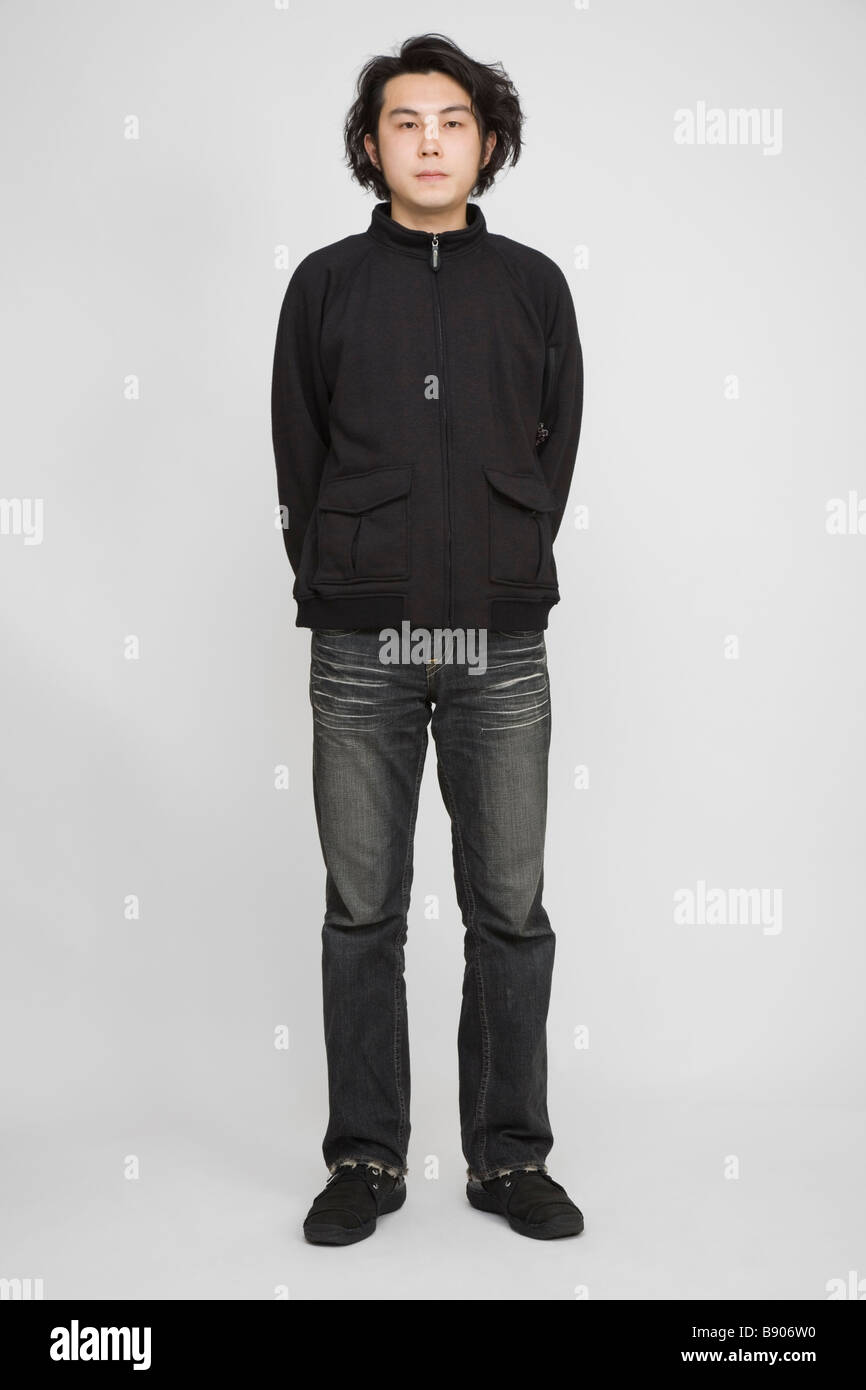 Portrait of a young man standing Stock Photo - Alamy