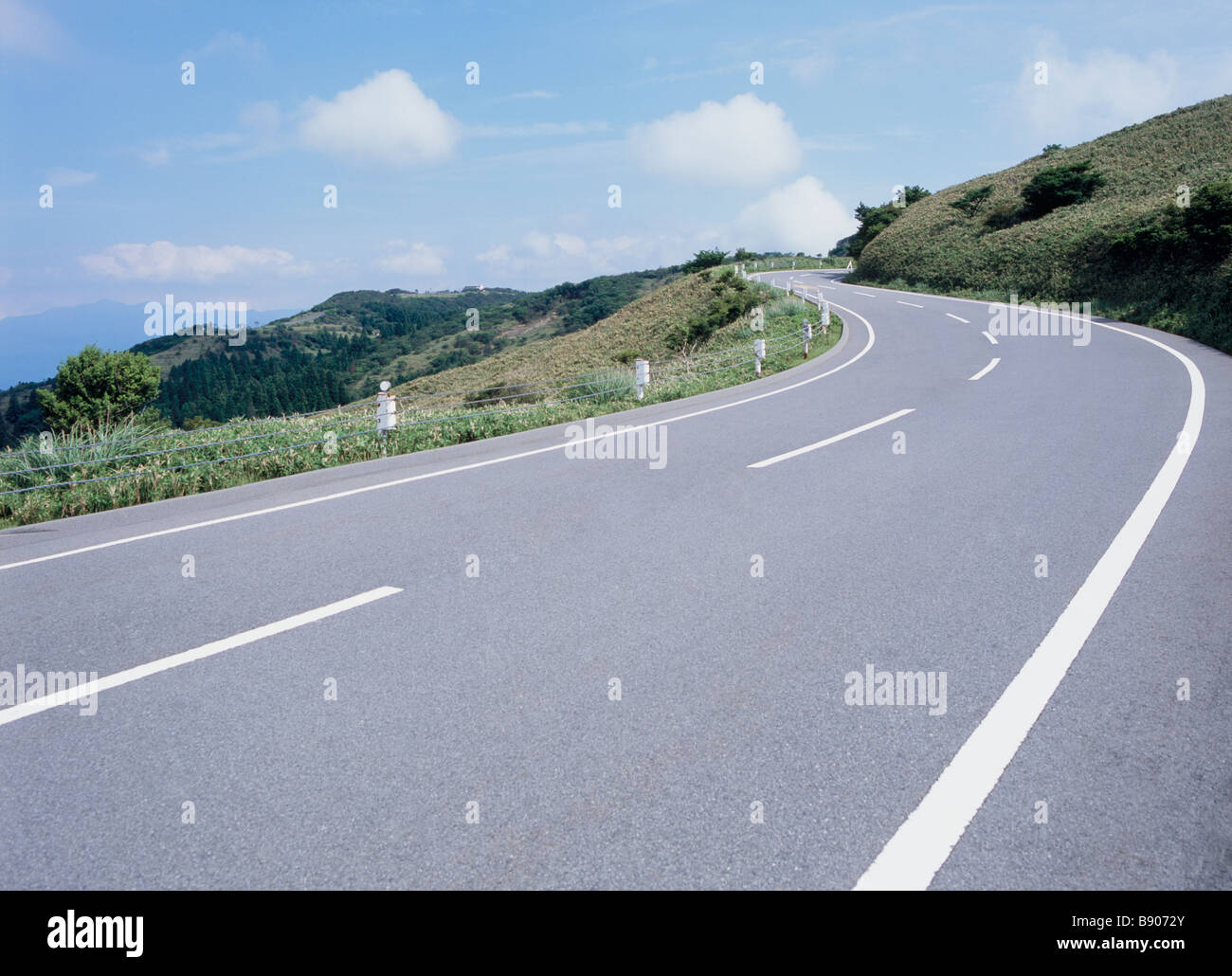 Left curve road through mountain Stock Photo - Alamy