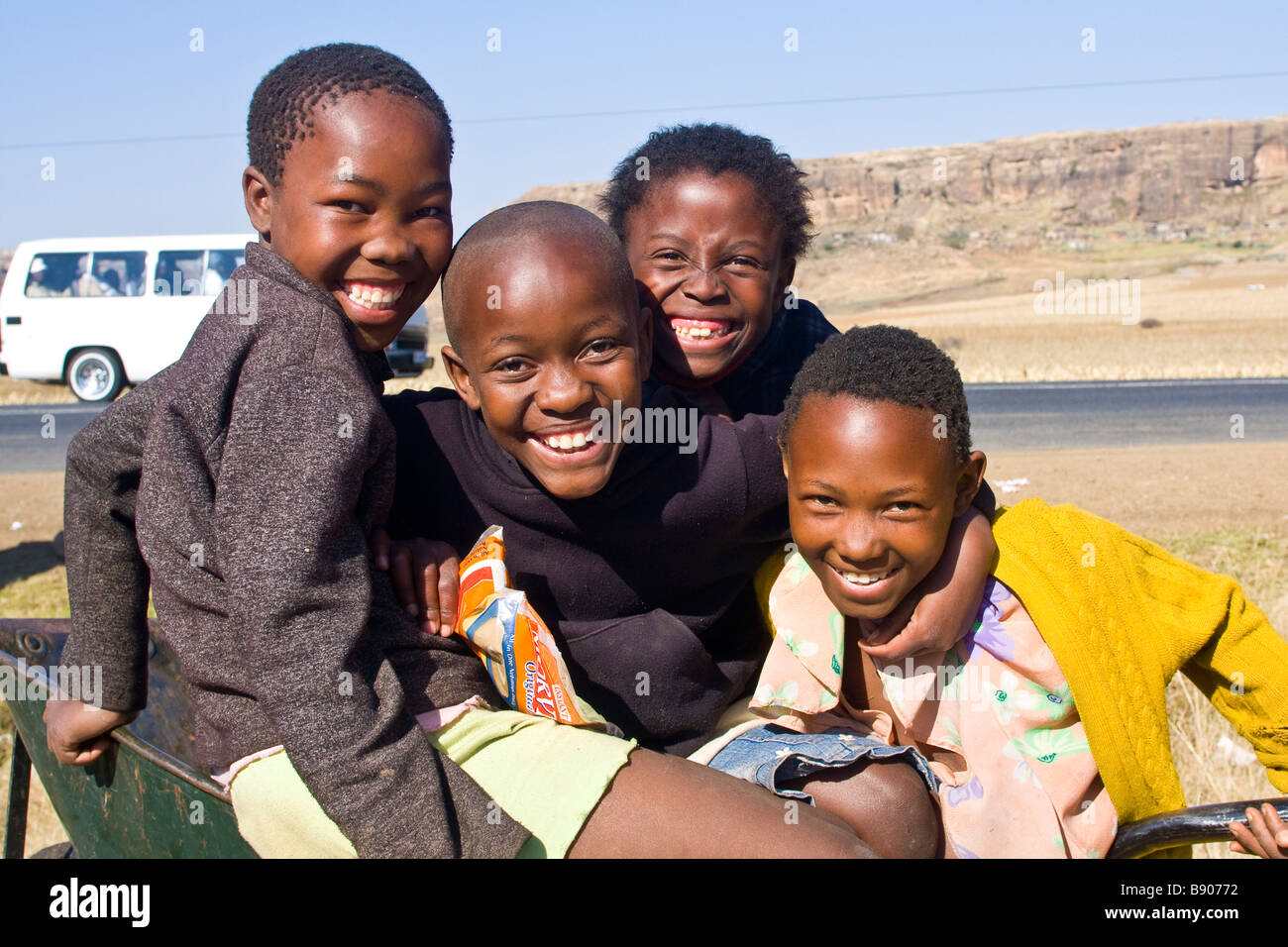 Children play on the side of the road in the countryside in the ...