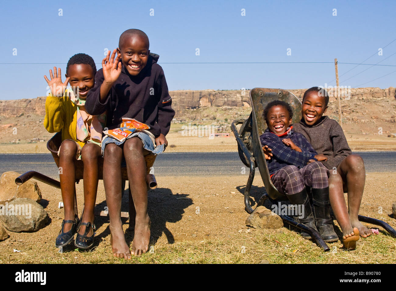 Children play on the side of the road in the countryside in the ...