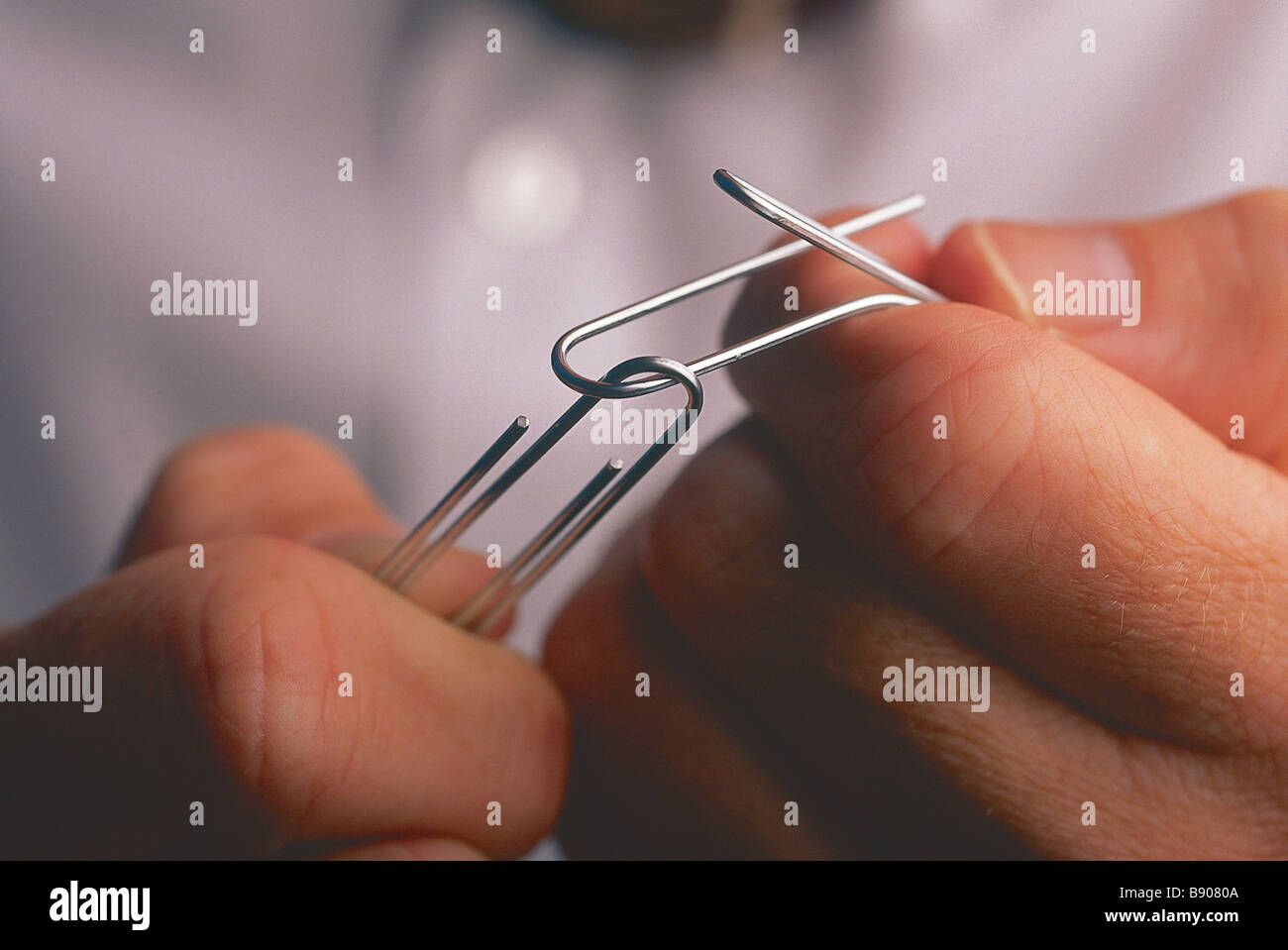 Paper clips holding hands hi-res stock photography and images - Alamy