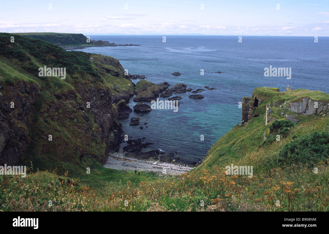 Coast path showing secluded beach and ruins of Findlater Castle on a ...