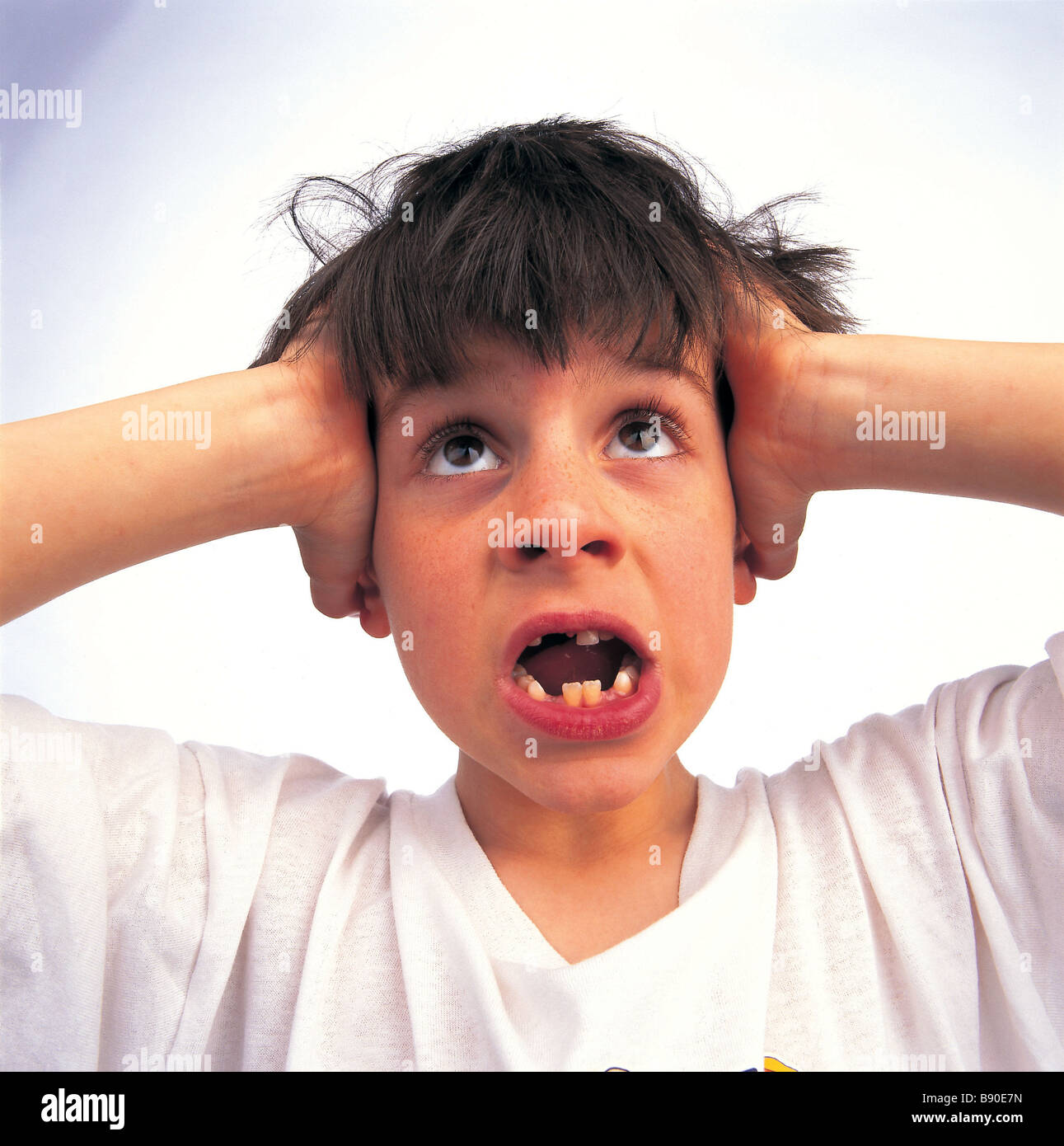 FL2564, RON ELMY; Exasperated boy holding hand to ears Stock Photo - Alamy