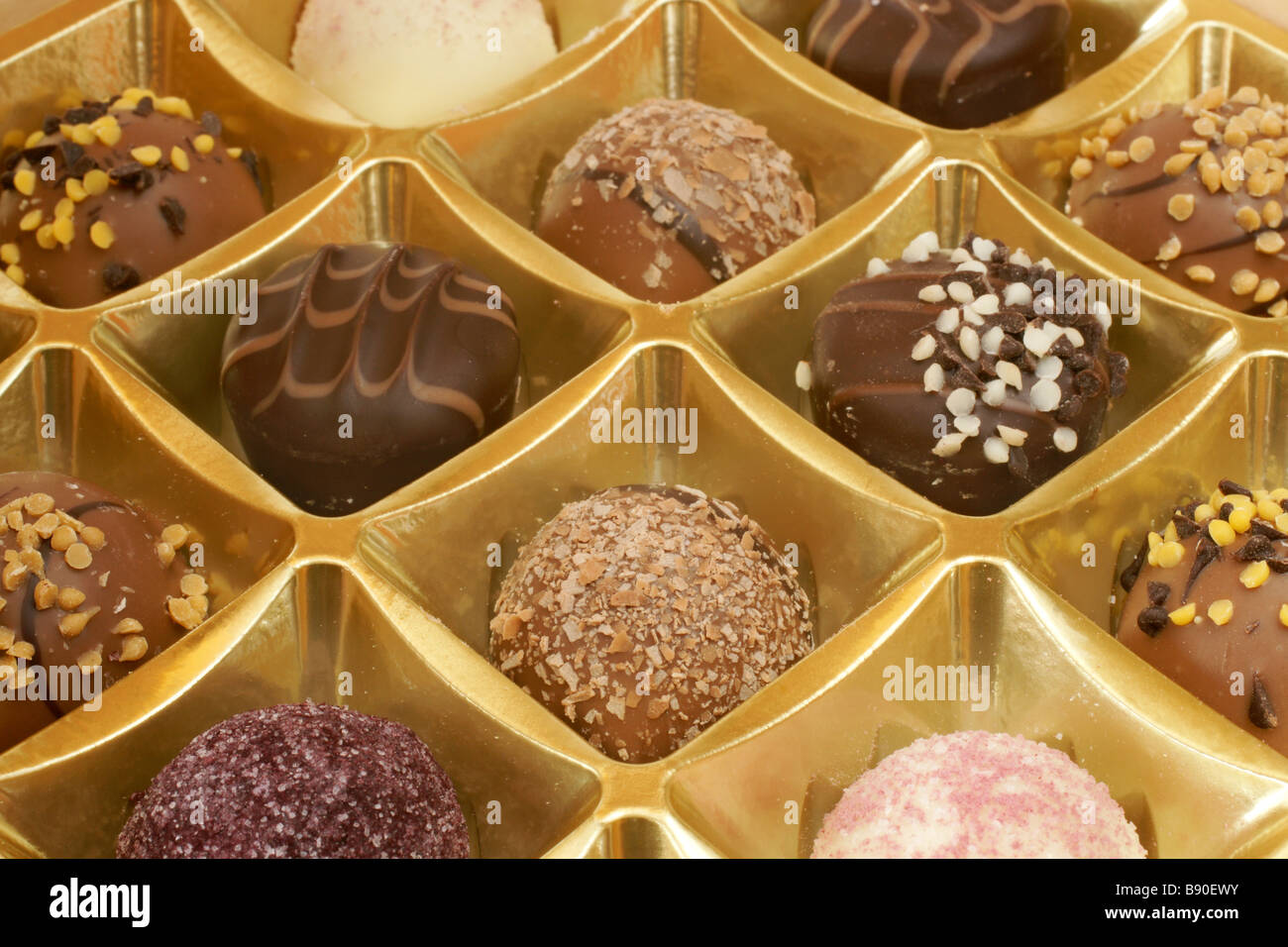 Delicious praline chocolate in a golden box Stock Photo - Alamy