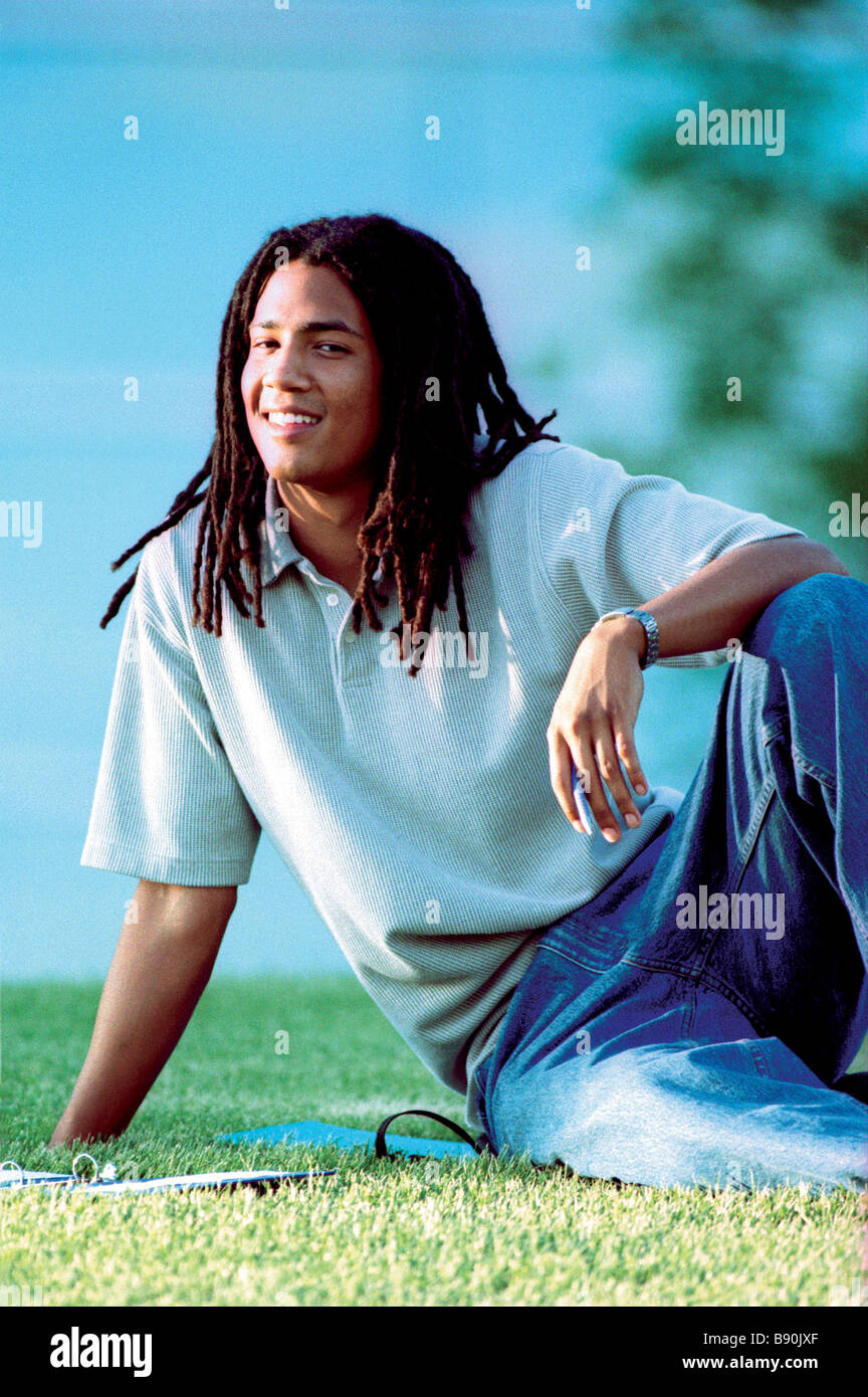 FL3306, BRIAN MILNE; Young man sitting park Stock Photo - Alamy