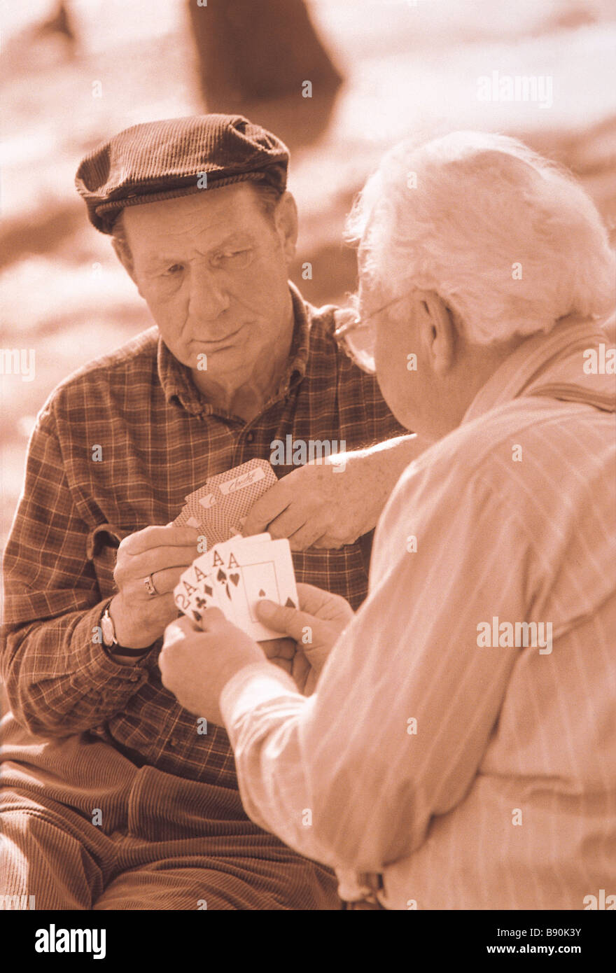 FL3402, TREVOR BONDERUD; Senior men playing cards park bench Stock ...