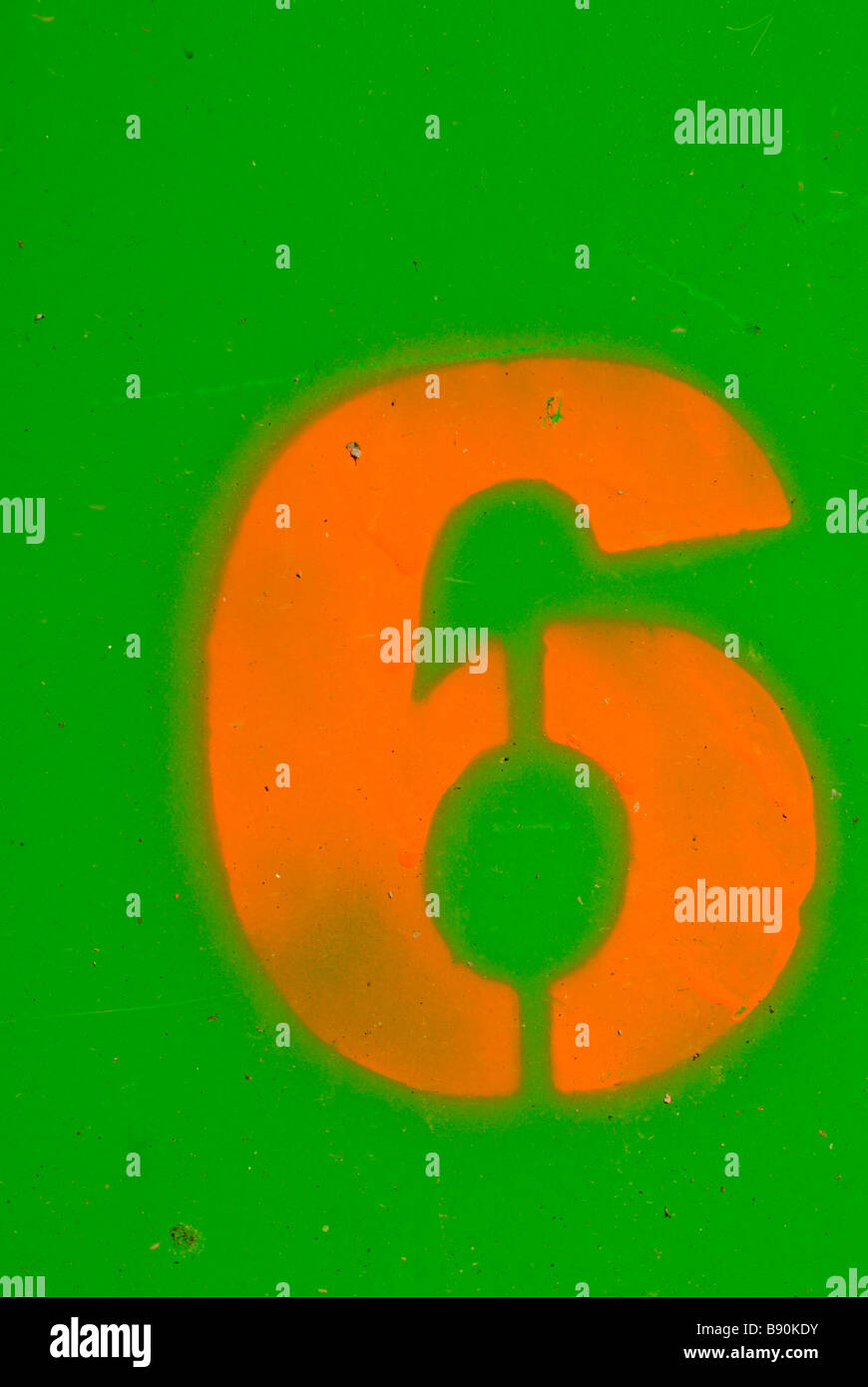 An orange number 6 stencilled on a green painted background Stock Photo ...