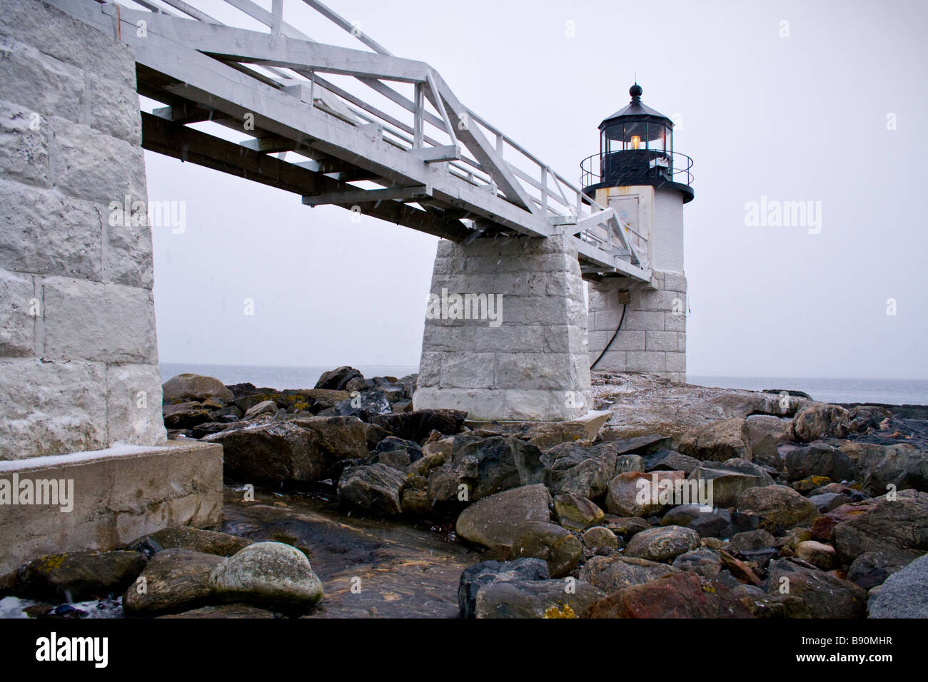 Marshall Point Lighthouse looks over the Atlantic Ocean on a snowy ...