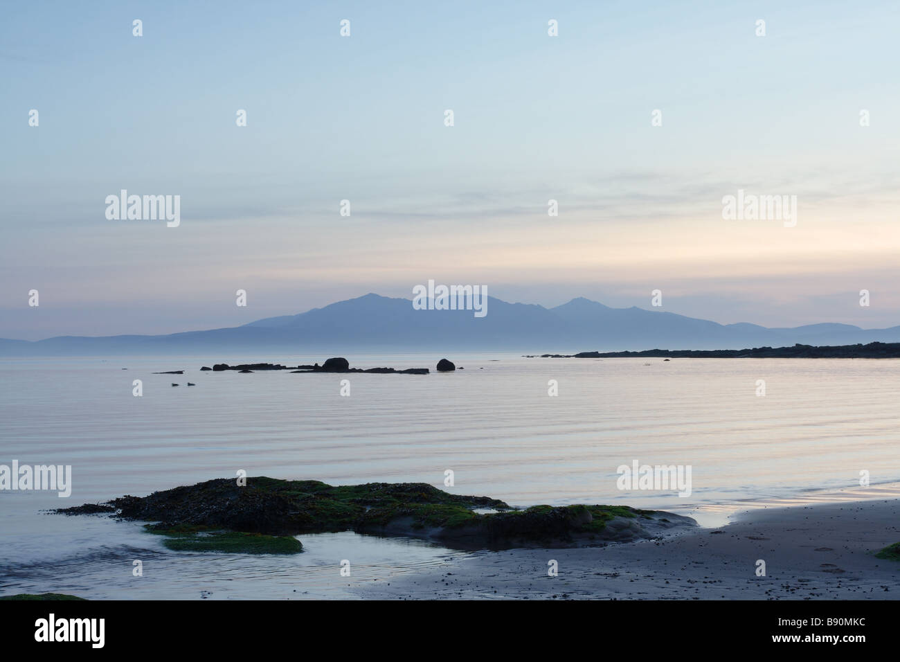 Looking towards the Island of Arran at sunset in the Firth of Clyde ...
