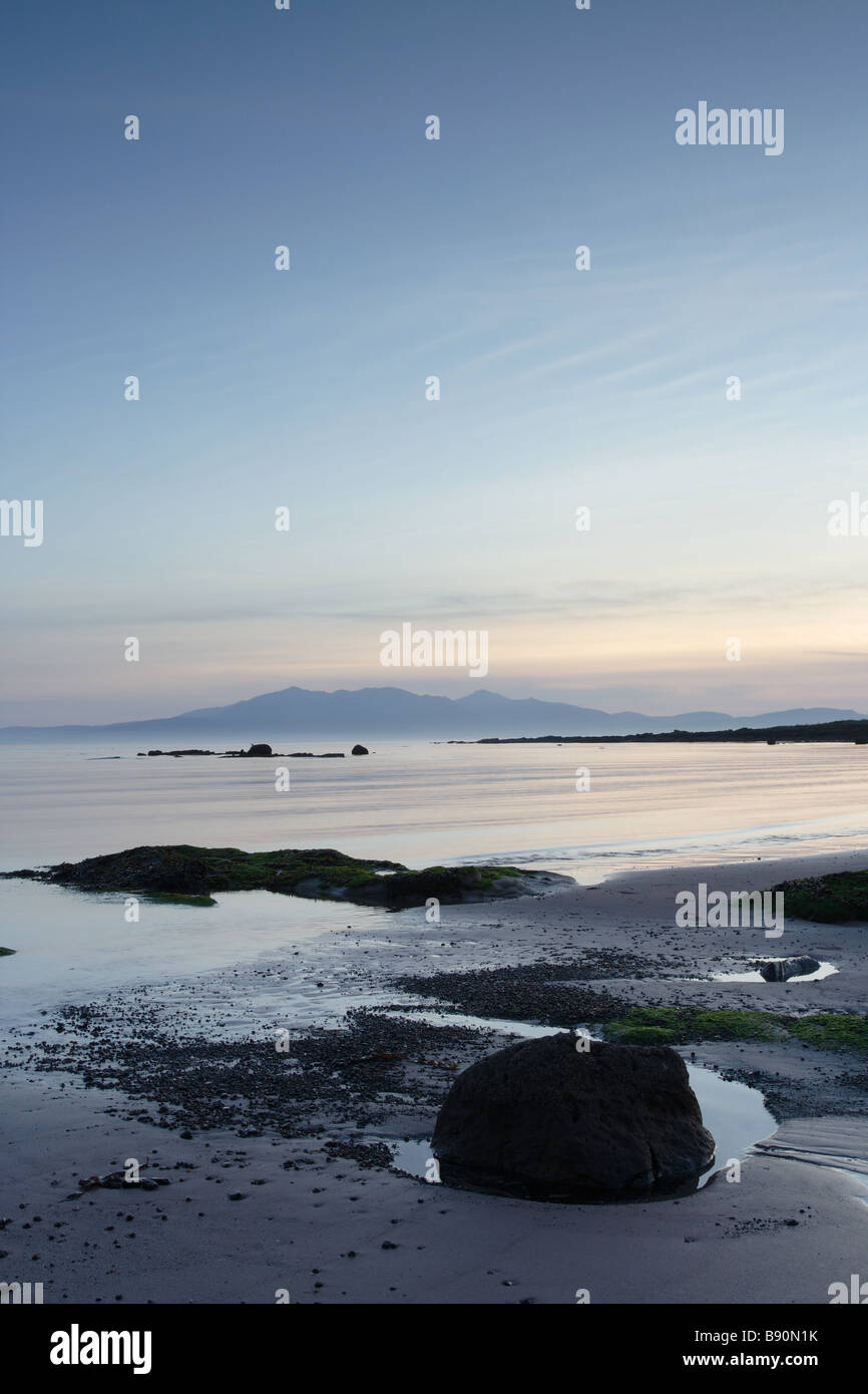 Looking towards the Island of Arran at sunset in the Firth of Clyde ...