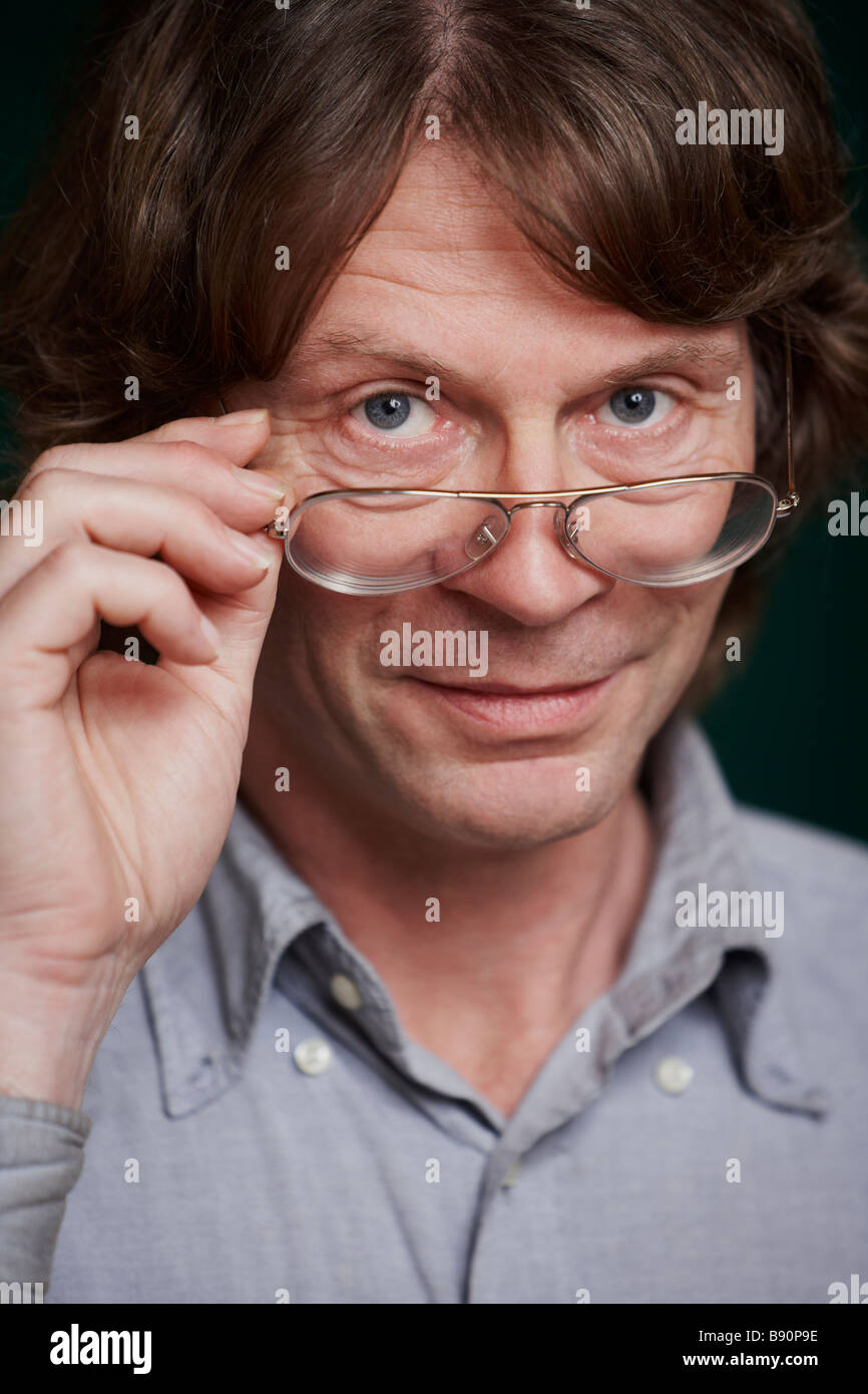 adult man looking over his glasses Stock Photo - Alamy