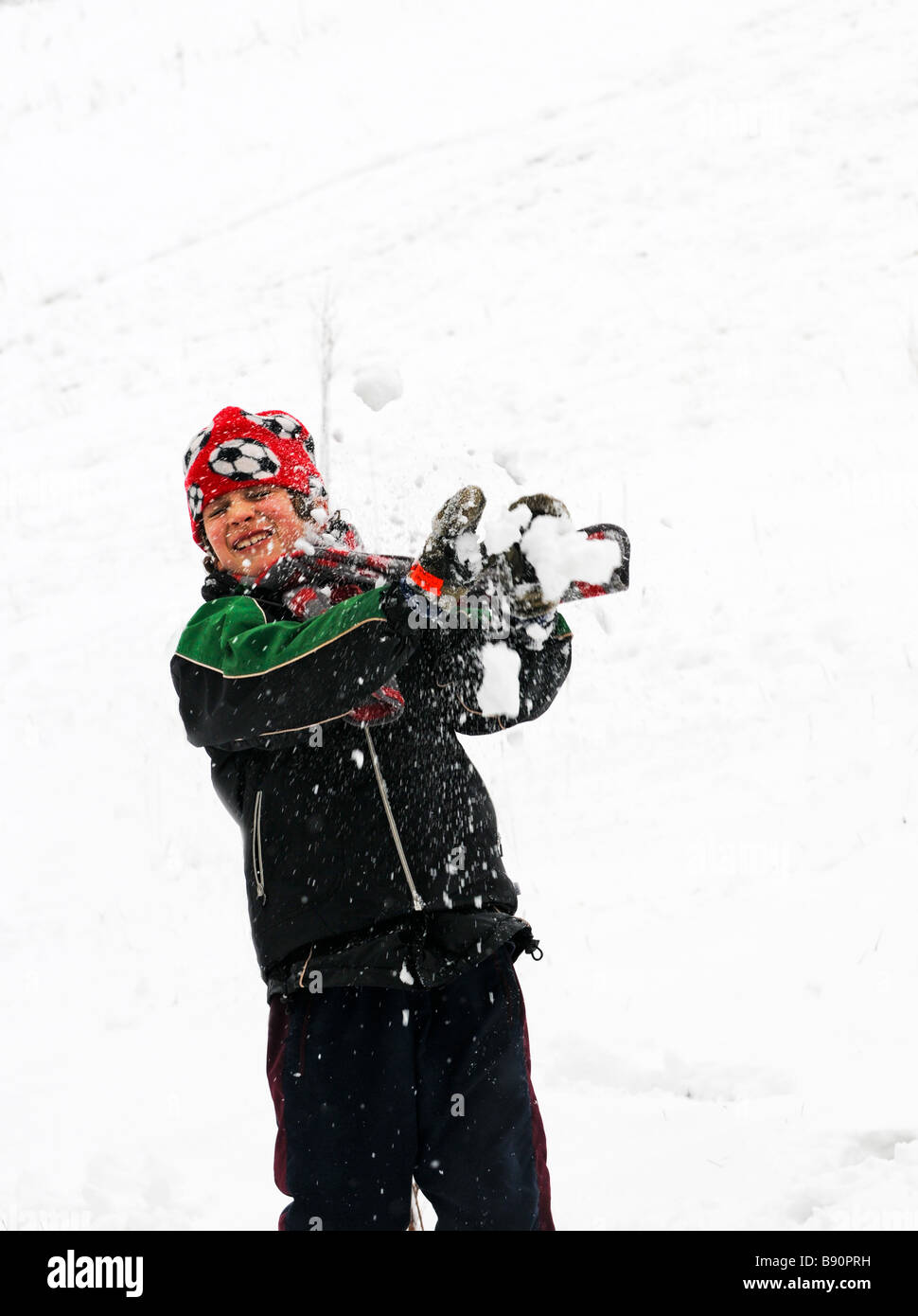 action shot of boy getting snowball in his face Stock Photo - Alamy